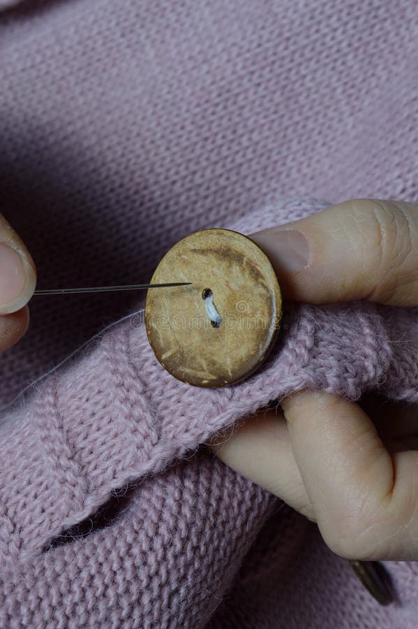 Female Workers` Hands Sew a Wooden Button To a Jacket. Close-up Stock ...