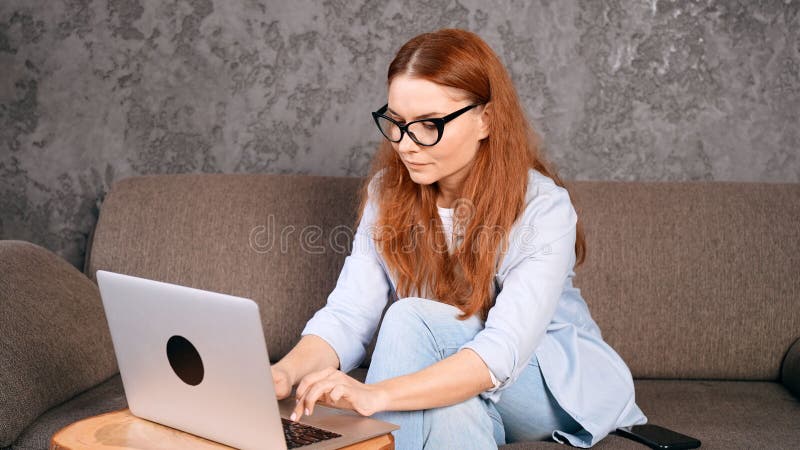 Female Working from Home Sitting on the Couch Stock Photo - Image of ...