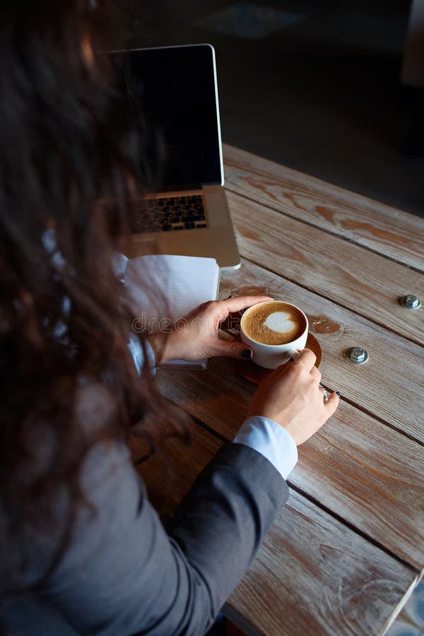 Female Working on Laptop in Cafe. White Mug of Coffee. Using Internet ...