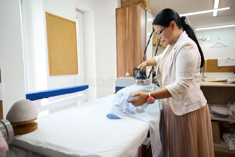 Female in Glasses in the Workshop Ironing Clothes Stock Photo - Image ...