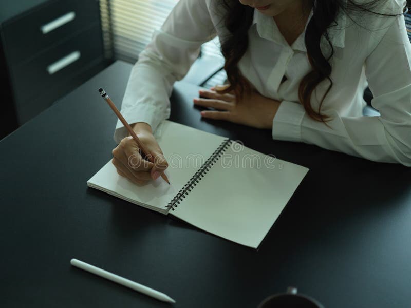 Female Writing on Notebook while Working in Office Room Stock Image ...