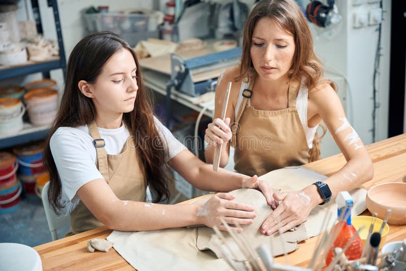 Females Making Artisan Plate in Professional Pottery Workshop Stock ...