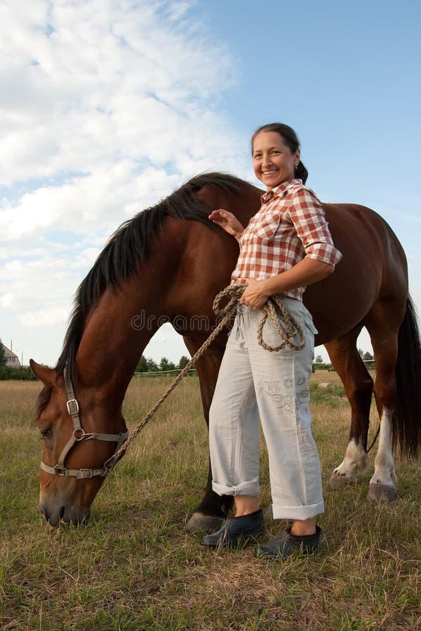 Les Jolis Femmes Avec Son Cheval Dans La Fleur Mettent En Place Photo ...