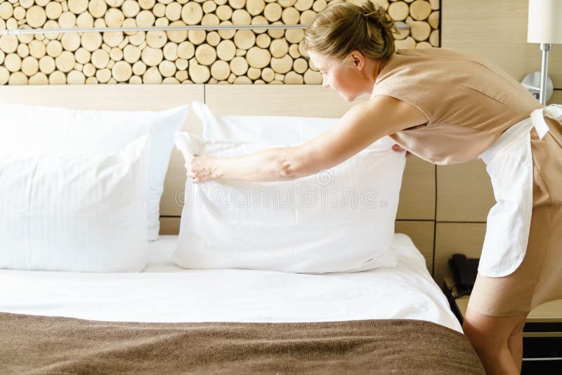 Femme De Chambre Faisant Un Lit Dans Une Chambre Dhôtel Photo Stock