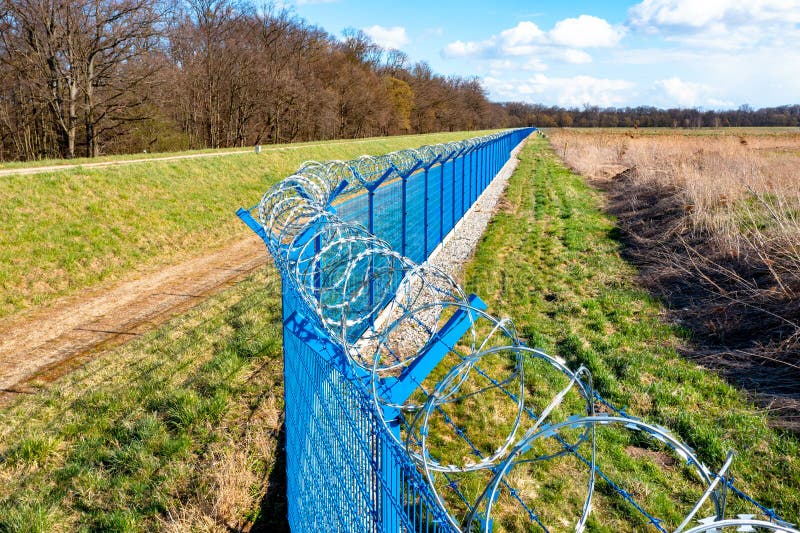 Fence with Barbed Wire at a Guarded Facility, it is Dangerous To Enter ...