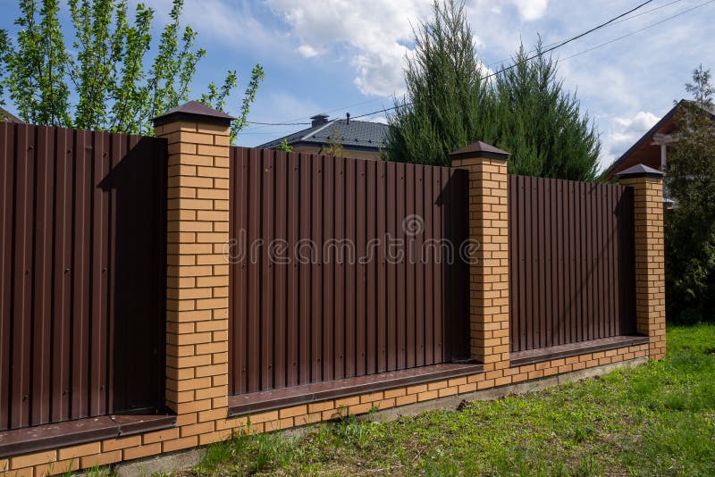 Fence or Fence of Brown Metal and Brick Columns. the Concept of Safety ...