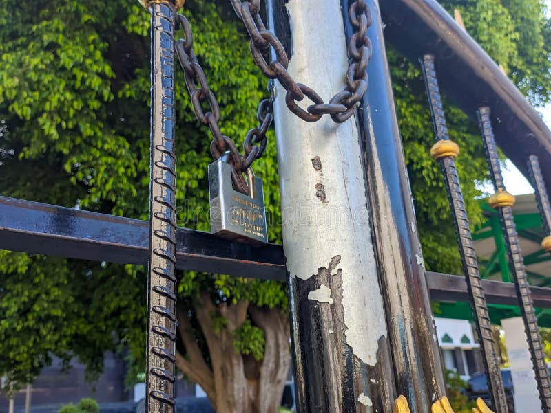 A Fence with a Chain and Padlock Attached Stock Image - Image of ...