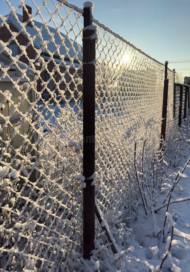 A Fence Covered in Snow and a Chain Link Fence Stock Image - Image of ...
