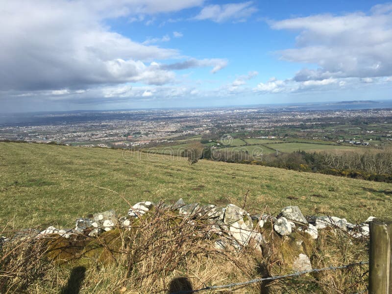 Fence of a Farm in Front of Vast Fields with a Blue Cloudy Sky in the ...
