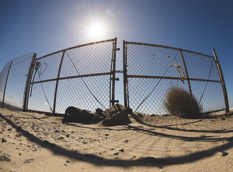 Fence Gate in Rocky Sand Beach Stock Photo - Image of chainlink, shore ...