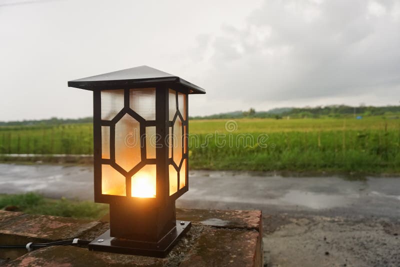 Fence Lamp with Golden Yellow Light. Lights on the Brick Fence Stock ...