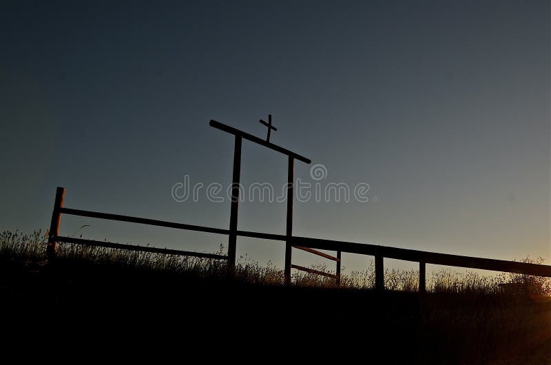 Fence Line Down a Slope with a Cross Stock Photo - Image of dawn ...