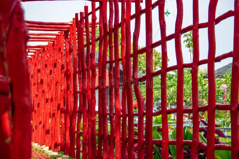 Fence Made of Logs Painted Red on the Path in the Park Stock Photo ...