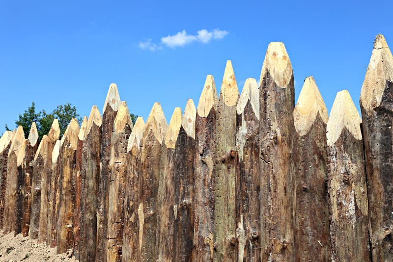 A Fence Made of Pointed Logs Stock Photo - Image of logs, strengthening ...