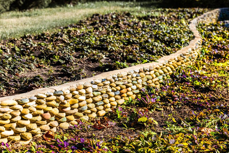 A Fence Made of Round Stones Extending into the Distance Stock Photo ...