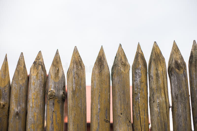 Fence Made of Sharp Wooden Stakes Against the Grey Sky Stock Image ...