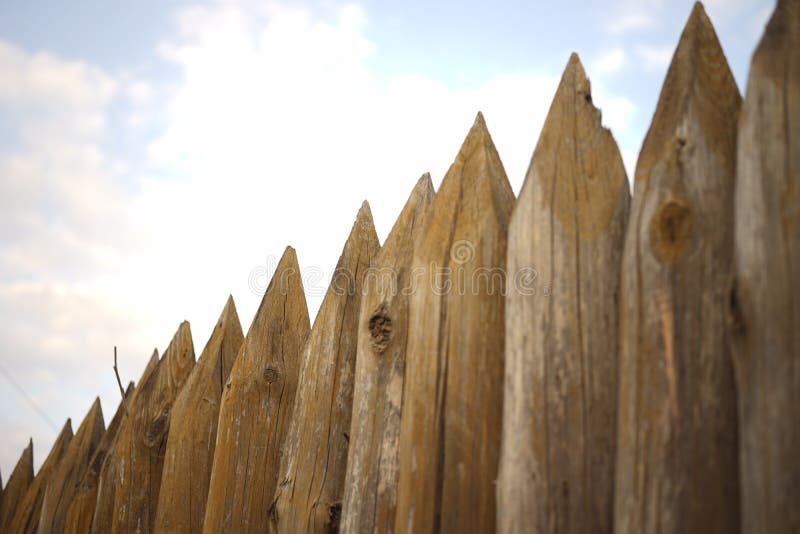 Fence Made of Sharp Wooden Stakes Under Blue Sky Stock Photo - Image of ...