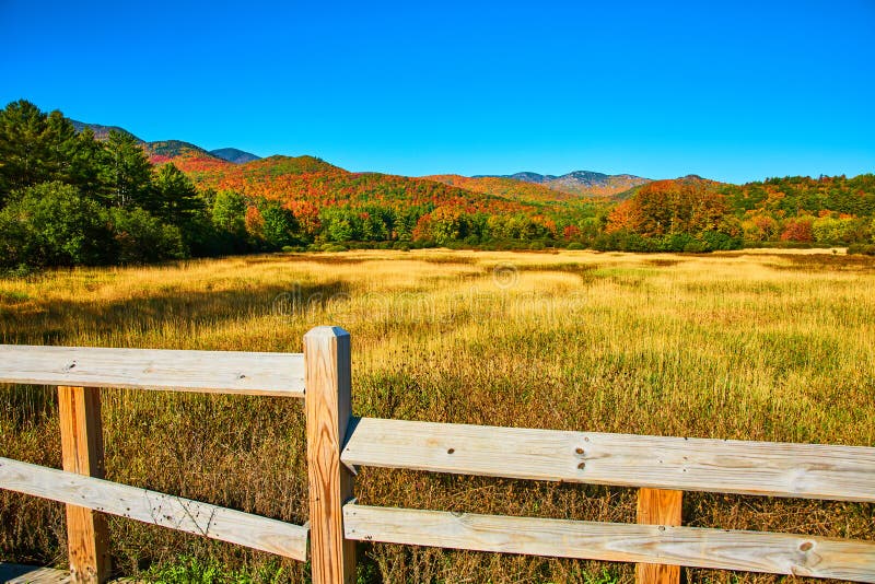 Fence Next To Yellow Fields and Huge Colorful Peak Fall Mountains in ...