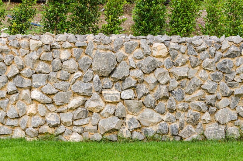 Fence Real Stone Wall Surface With Cement On Green Grass Field Stock ...