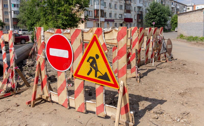 A Fence with a Road Works Sign and a Stop Sign Were Placed on the Road ...