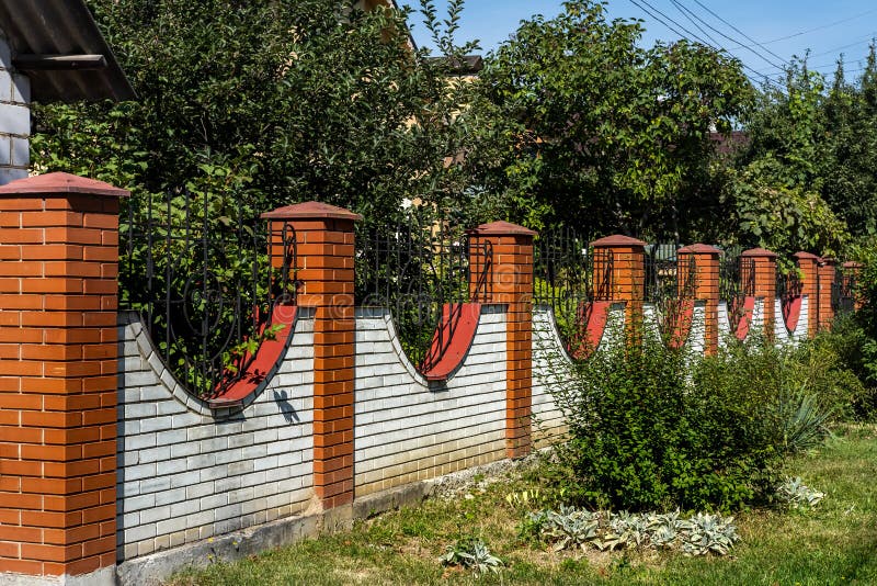 Fence With Steel Rods And Pillars Of Brick Stock Image - Image of ...