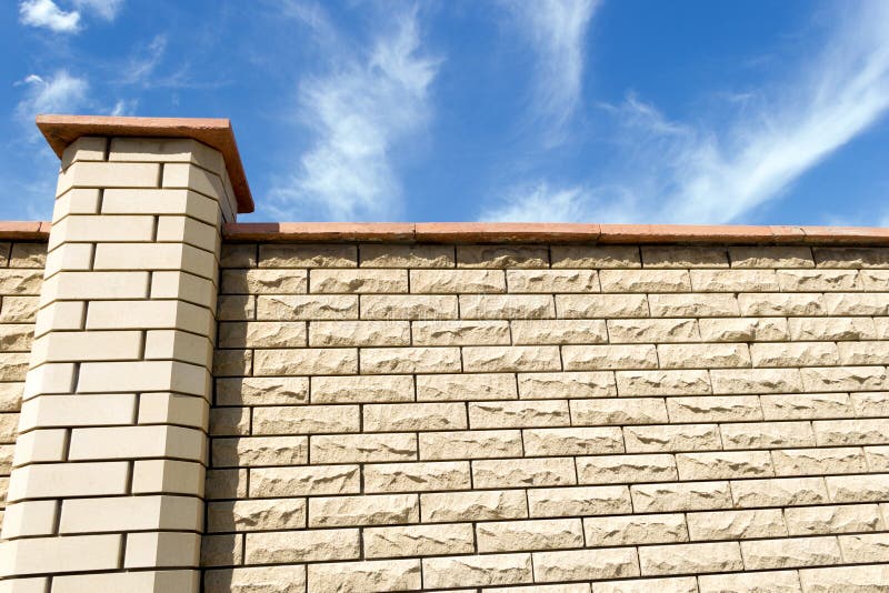 Fence Wall Lined with Sand Bricks. View from Down. Blue Cloudy Sky ...