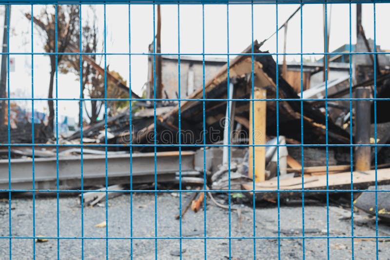 Abstract Burned Building Behind Construction Fence. Stock Photo - Image ...