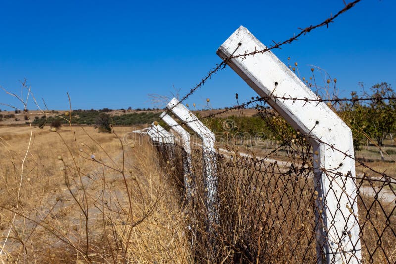 Fencing of White Poles with Barbed Wire in the Field Stock Image ...