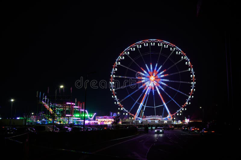 Brightly Lit Ferris Wheel and Fairground Rides by Night. Editorial ...