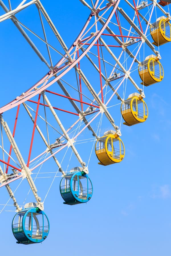 Ferris Wheel with Colorful Baskets on Blue Sky Background Stock Photo ...