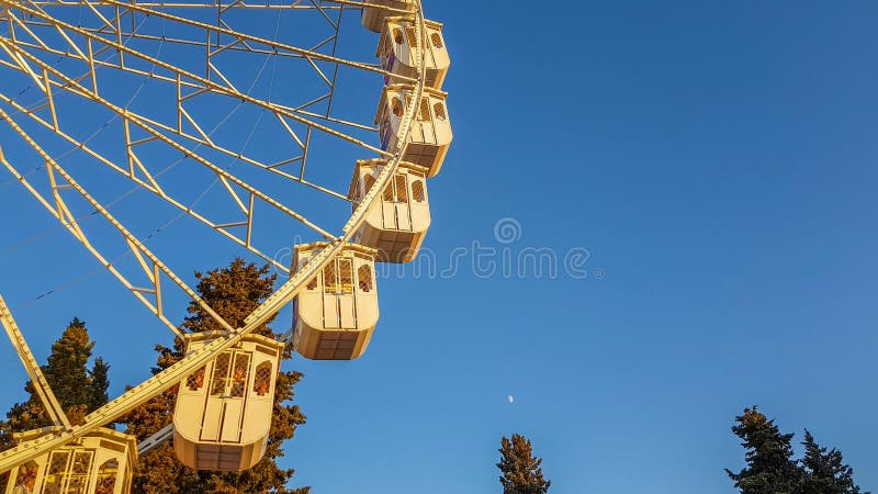 Ferris Wheel at Evening with Moon Visible Stock Image - Image of city ...