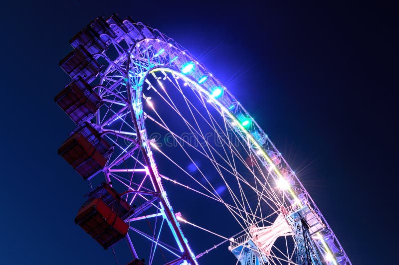 Ferris Wheel with Multi-colored Illumination Against the Dark Bl Stock ...