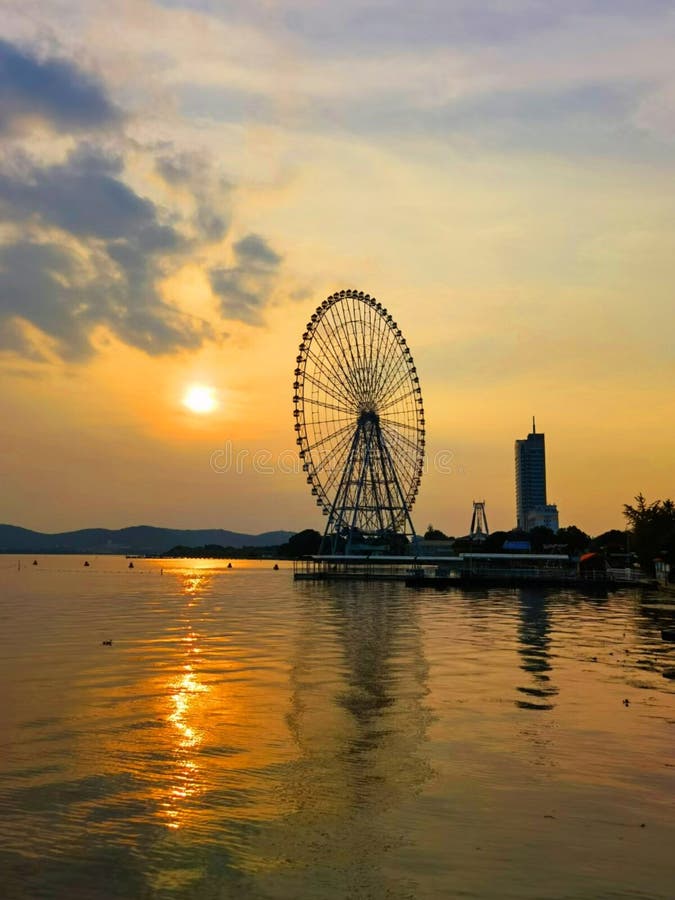 Ferris wheel at sunset stock photo. Image of sunlight - 232952518