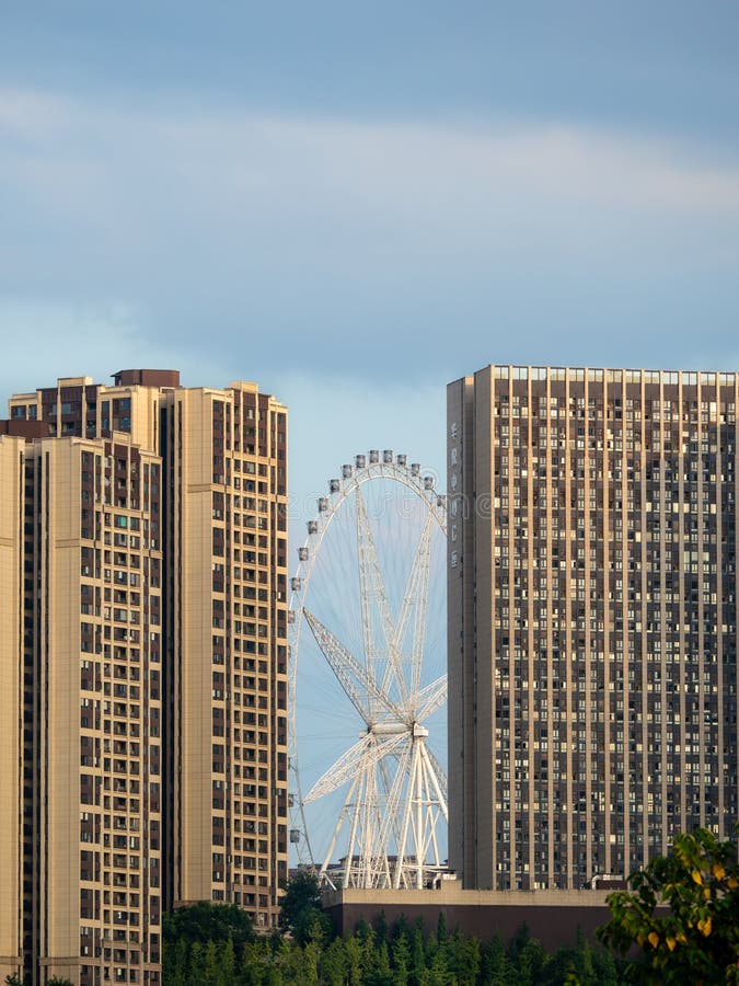 Ferris wheel and buildings stock photo. Image of engineering - 327411330