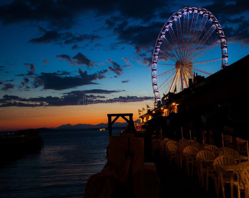 Ferris Wheel on the Water at Sunset Stock Photo - Image of fairground ...