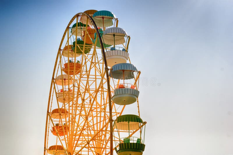 Ferris Wheel-yellow with Multi-colored Booths Stock Image - Image of ...