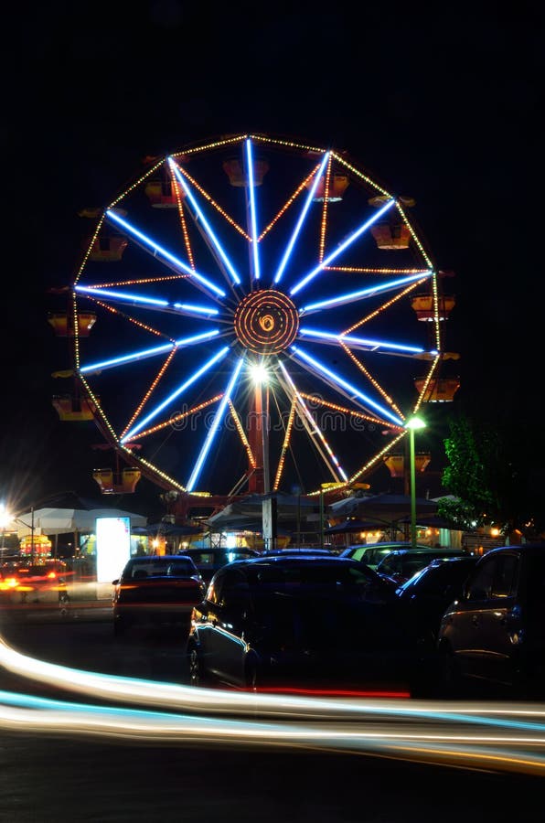 Ferris wheels at night stock photo. Image of glow, light - 65772226