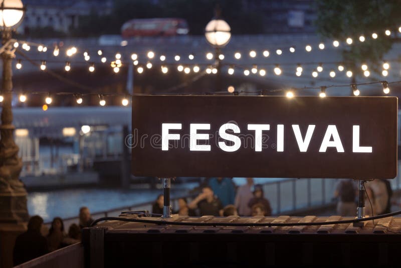 Festival Sign with Blurred String Lights in the Background Stock Photo ...