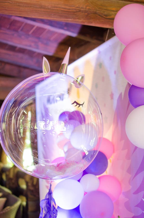 A Festive Ball with Feathers Inside in the Form of a Unicorn. Stock ...