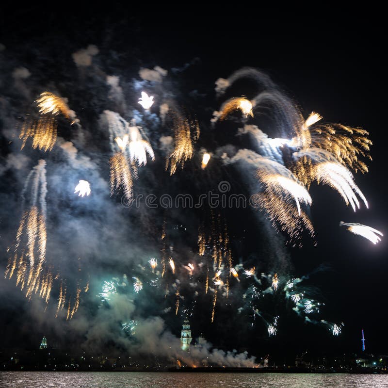 Festive Fireworks in the Dark Sky with Reflection in the Water of the ...