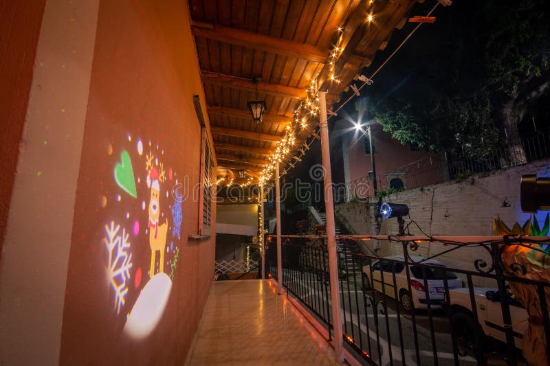 Festive Night Scene: a Balcony Decorated with Lights and a Projected ...