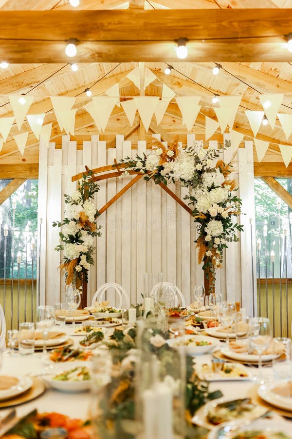 Festive Setting Table with Meals for Wedding, Wooden Arch, Stands ...