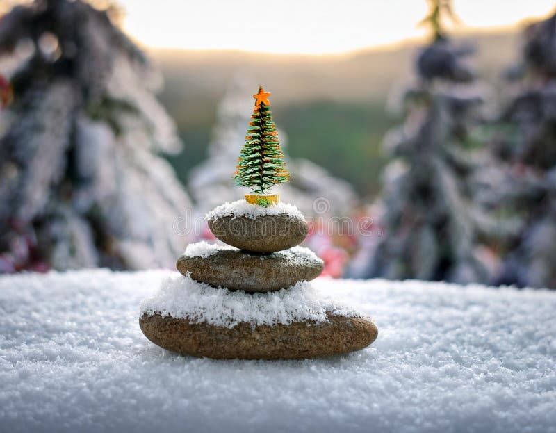 Festive Stack of Pebbles with Mini Christmas Tree and Snow-Covered ...