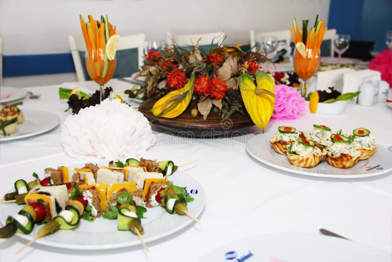 Festive Table Decoration with Salads, Snacks and a Bouquet of Flowers ...