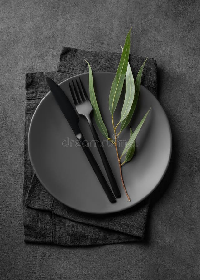 Festive Table Setting with Empty Gray Plate and Black Cutlery for ...