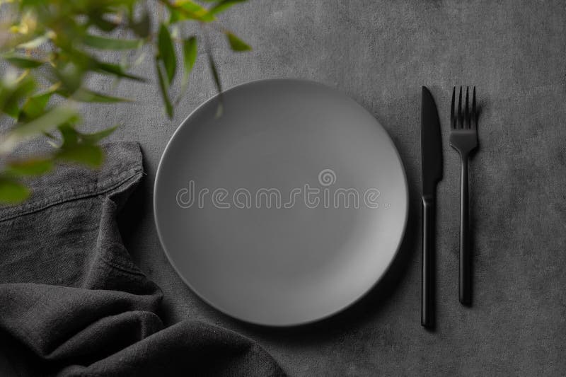 Festive Table Setting with Empty Gray Plate and Black Cutlery for ...
