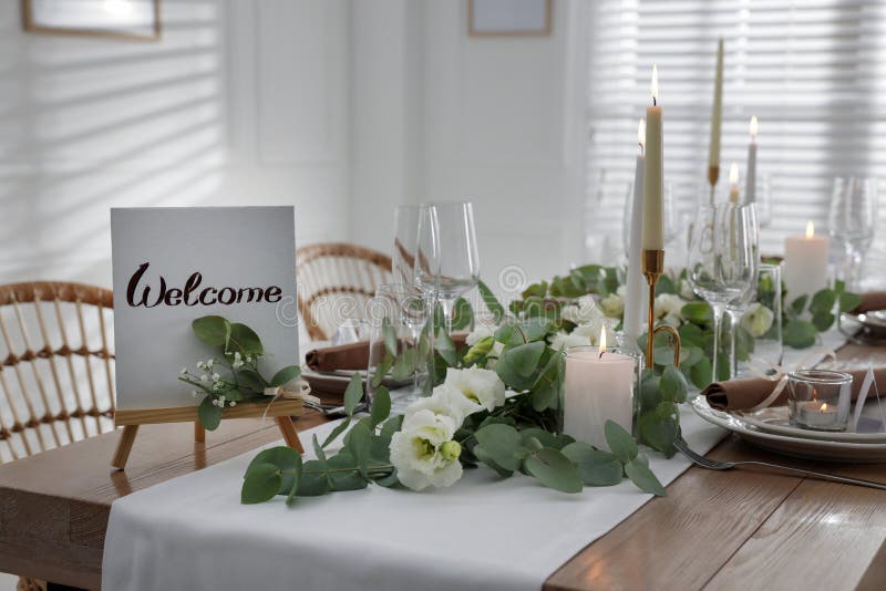 Festive Table Setting with Floral Decor and Welcome Sign Indoors Stock ...