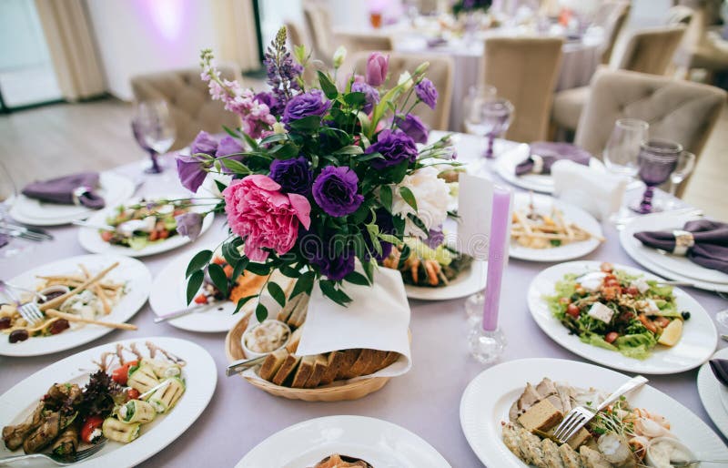 Festive Table Setting with Food on Plate and Purple Flowers Stock Photo ...