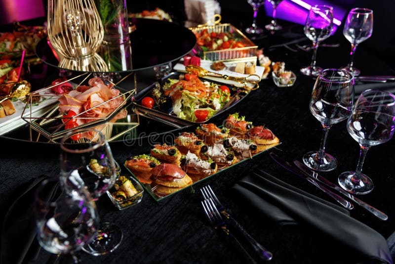 Festive Tables with Decor on Black Tablecloth and Snacks Ready for ...