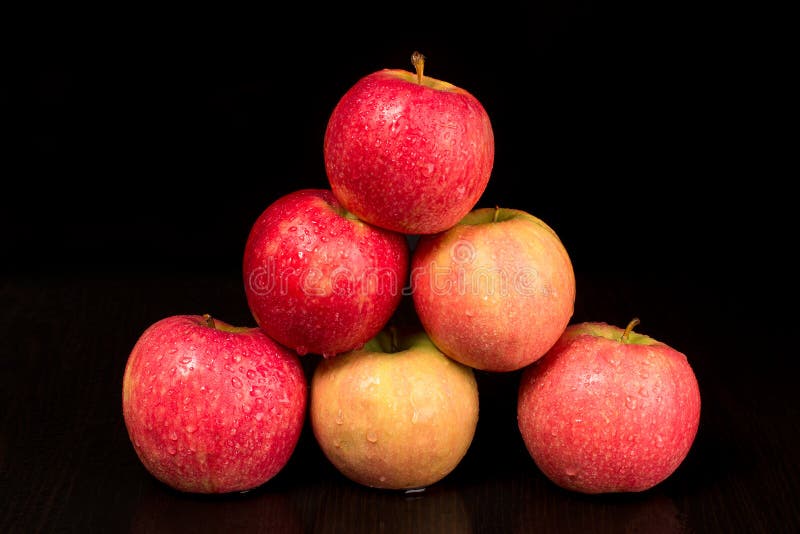 A Few Apples Stacked Slide, on a Black Background, Water Drops on ...